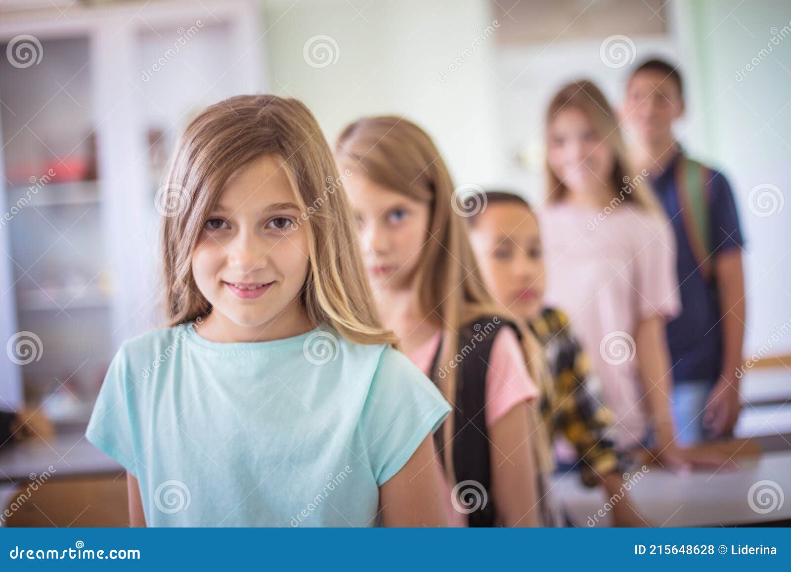 Large Group of School Children Standing in Classroom. Looking at Camera ...