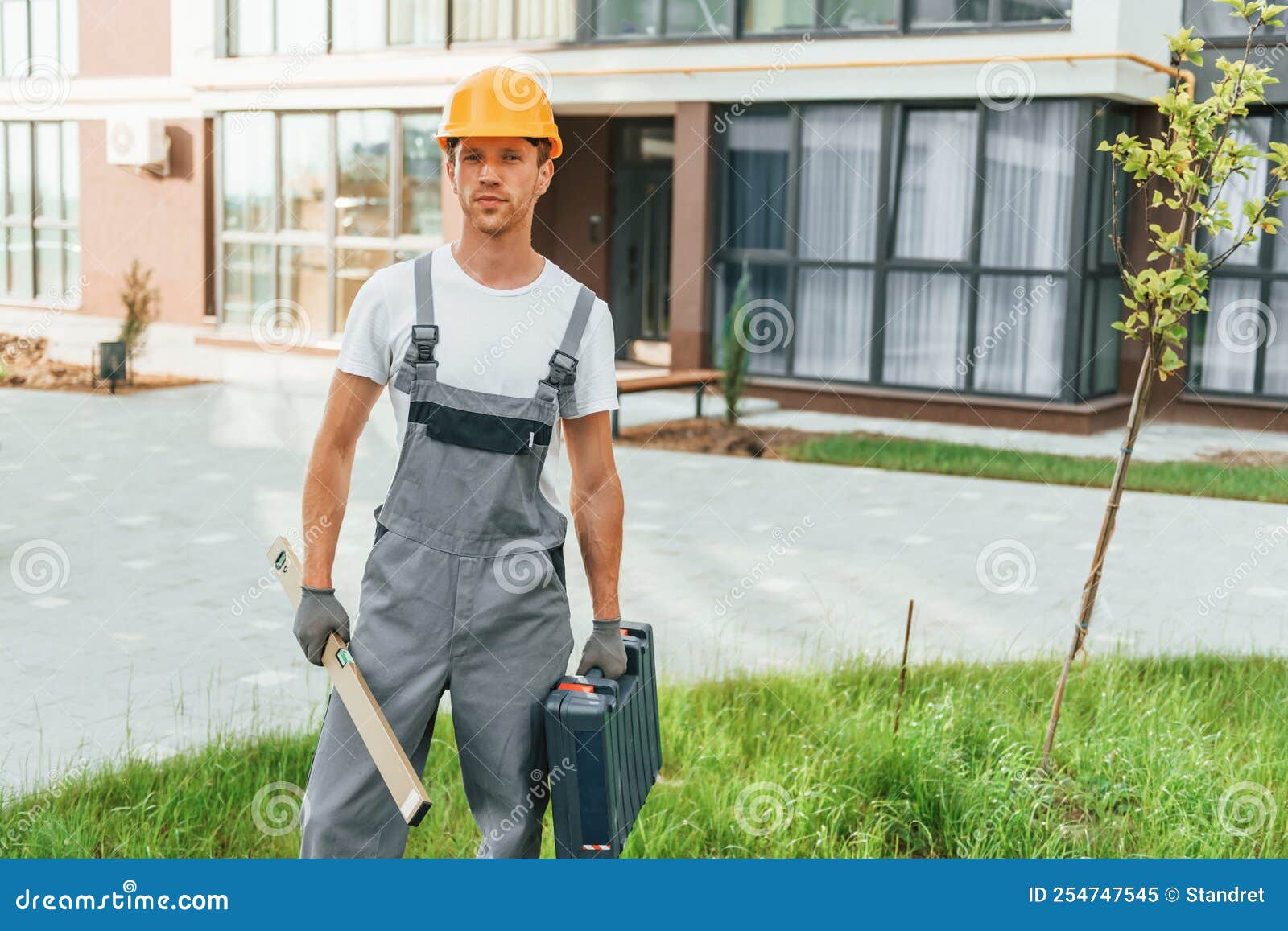 Ready for Work. Young Man in Uniform at Construction at Daytime Stock ...
