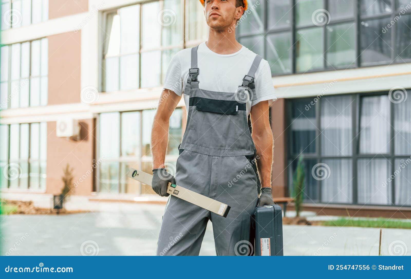 Ready for Work. Young Man in Uniform at Construction at Daytime Stock ...