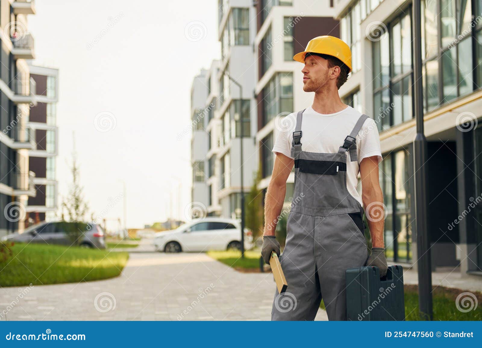 Ready for Work. Young Man in Uniform at Construction at Daytime Stock ...