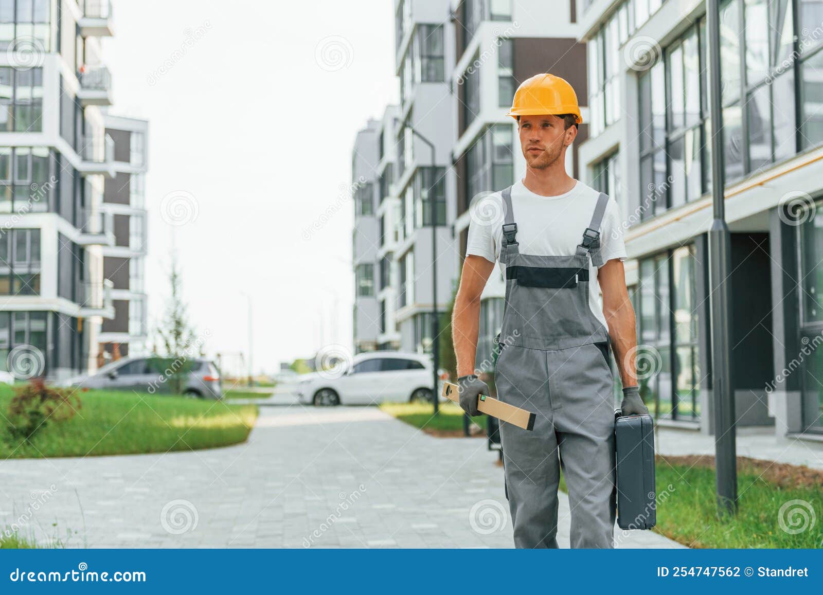 Ready for Work. Young Man in Uniform at Construction at Daytime Stock ...