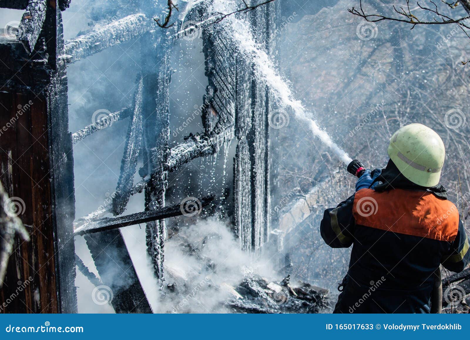 Real Firefighter With House On Fire In Background Royalty-Free Stock ...