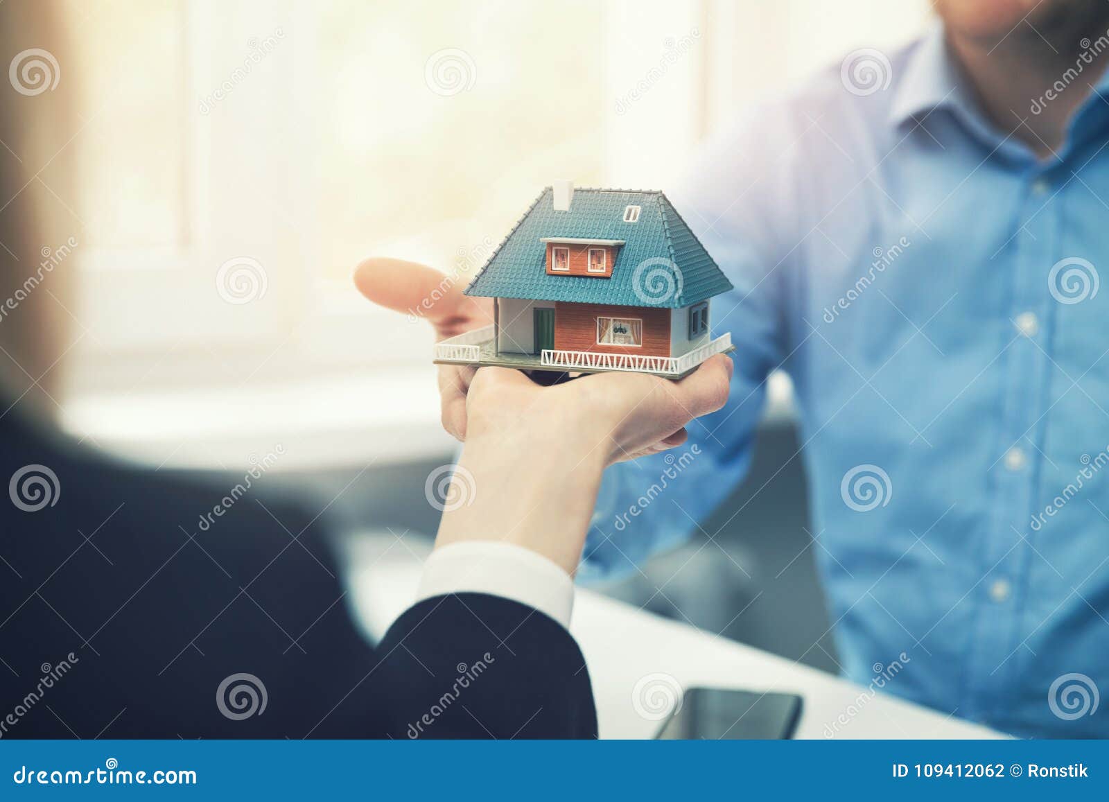 Real Estate Agent Architect Presenting House Model To Customer Stock ...