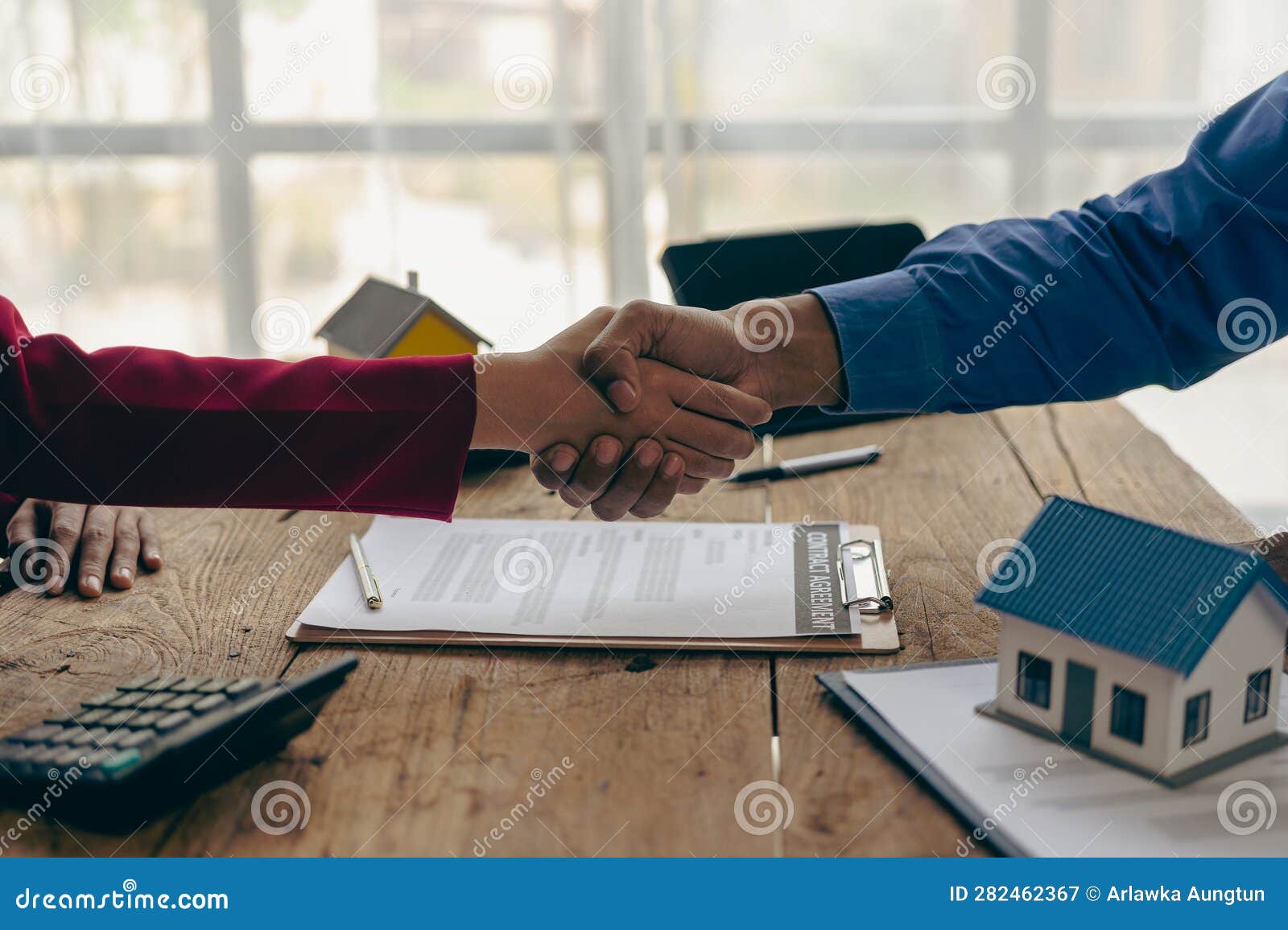 Real Estate Agent and Client Celebrating Contract Completion after ...