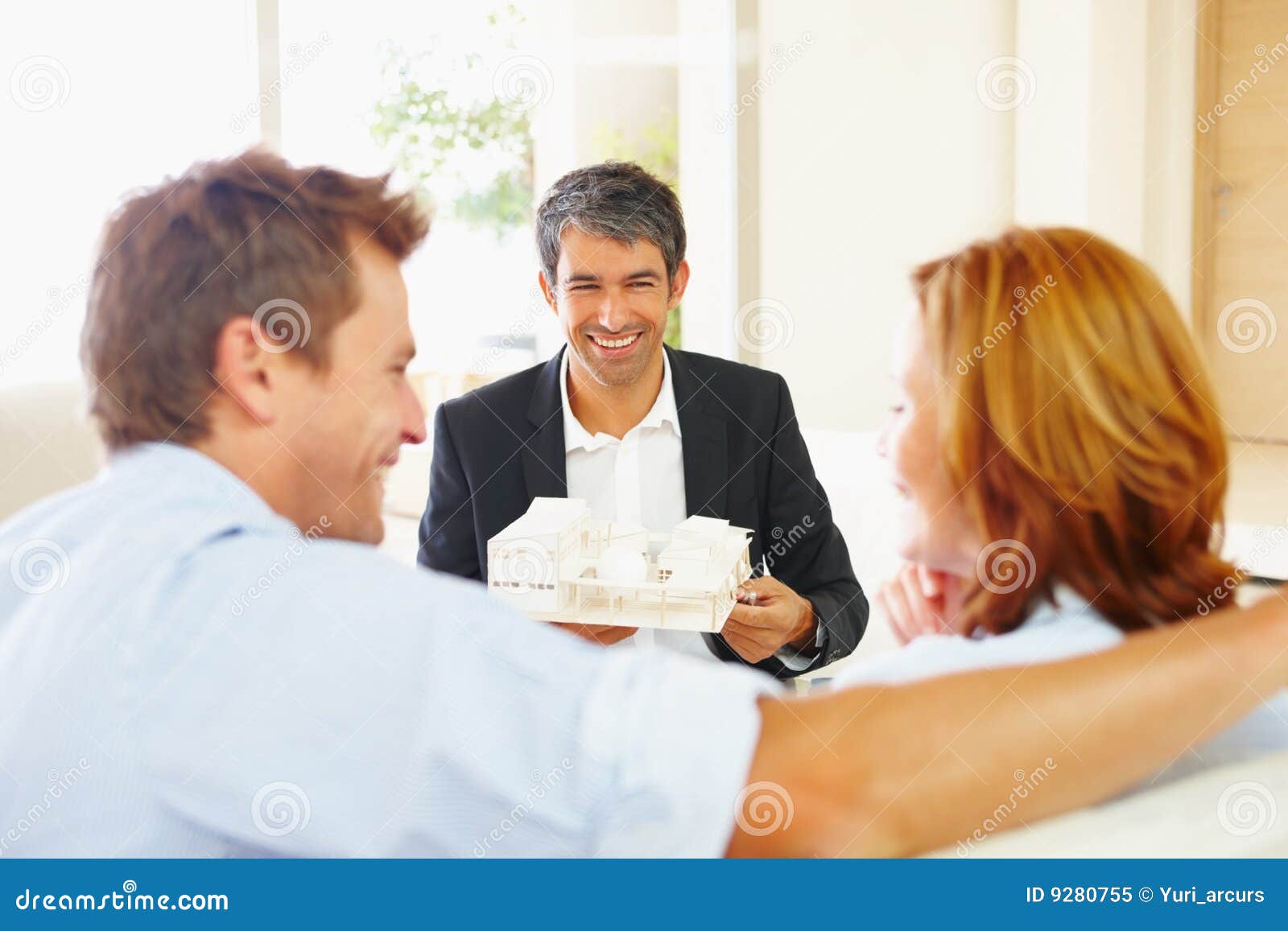 Real Estate Agent Discussing Plans with a Couple Stock Image - Image of ...