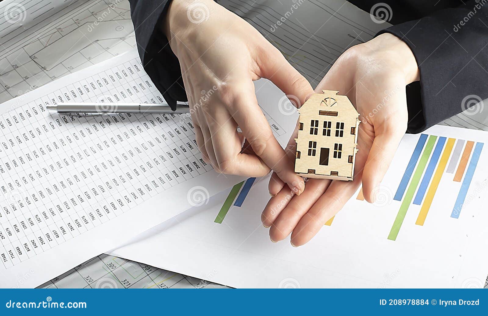 Real Estate Agent with House Model and Chart on Table Stock Photo ...