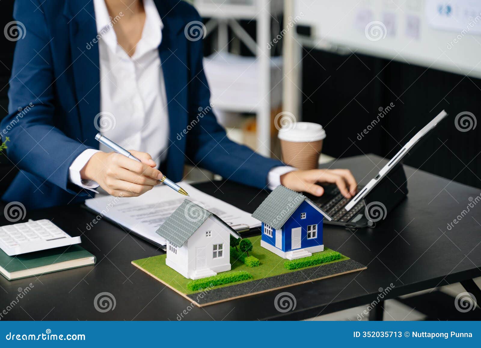 Real Estate Agent Worker Working with Laptop and Tablet at Table in ...