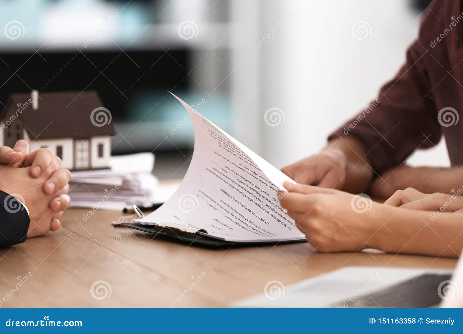 Real Estate Agent Working with Clients in Office Stock Photo - Image of ...