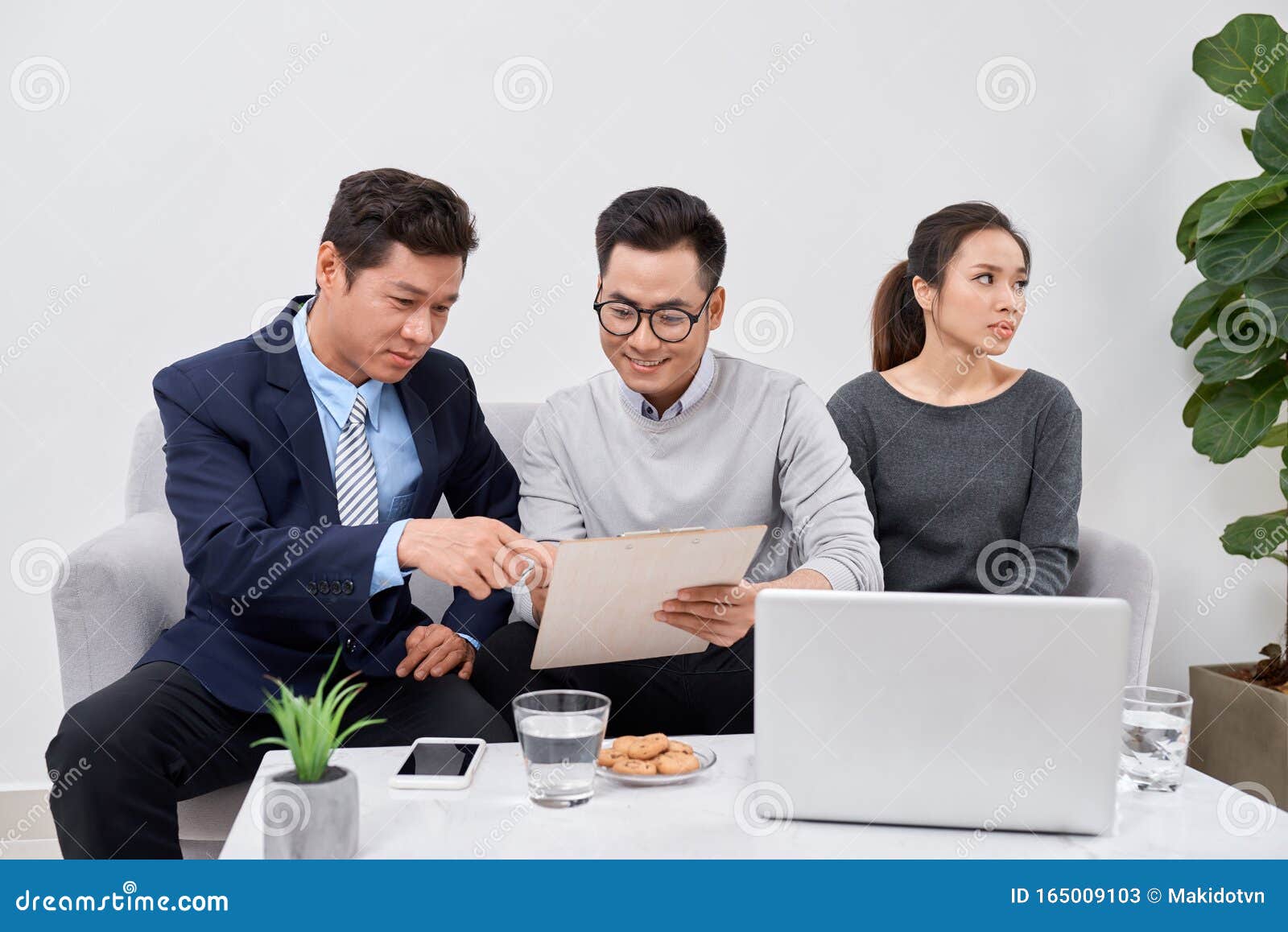 Real Estate Agent Working with Couple of Customers in the Office Stock ...