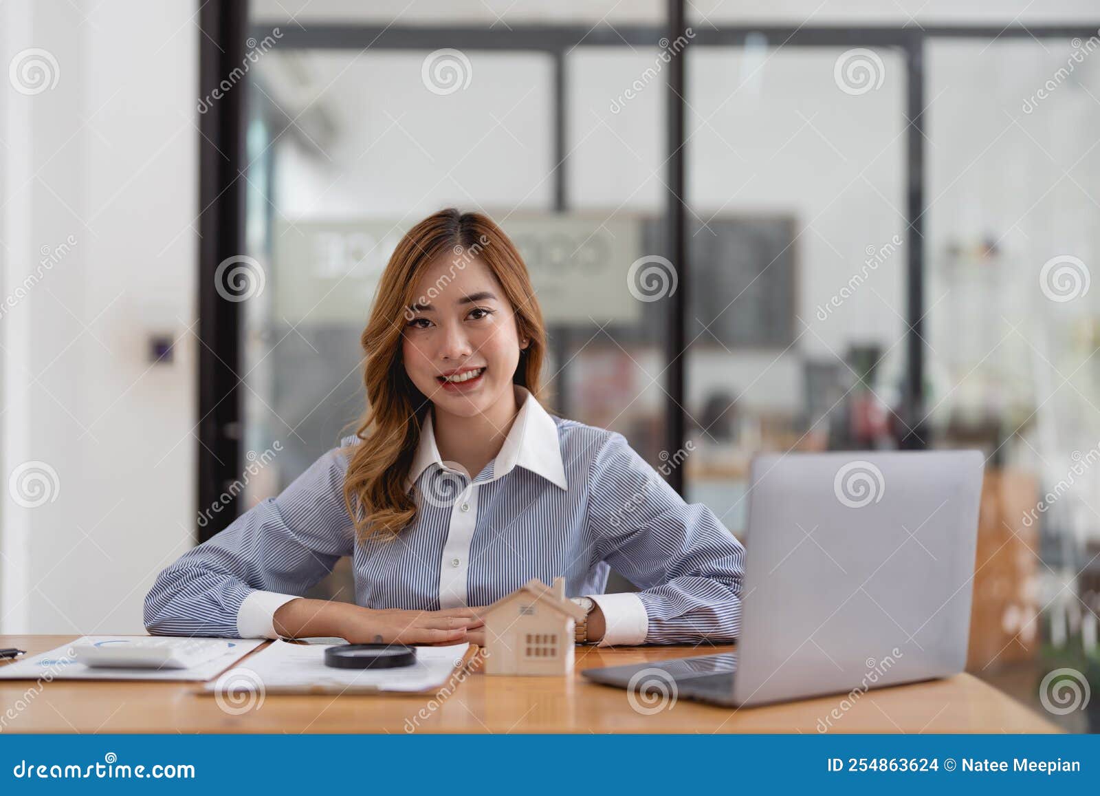 Real Estate Agent Working with Laptop at Table in Office. Stock Photo ...