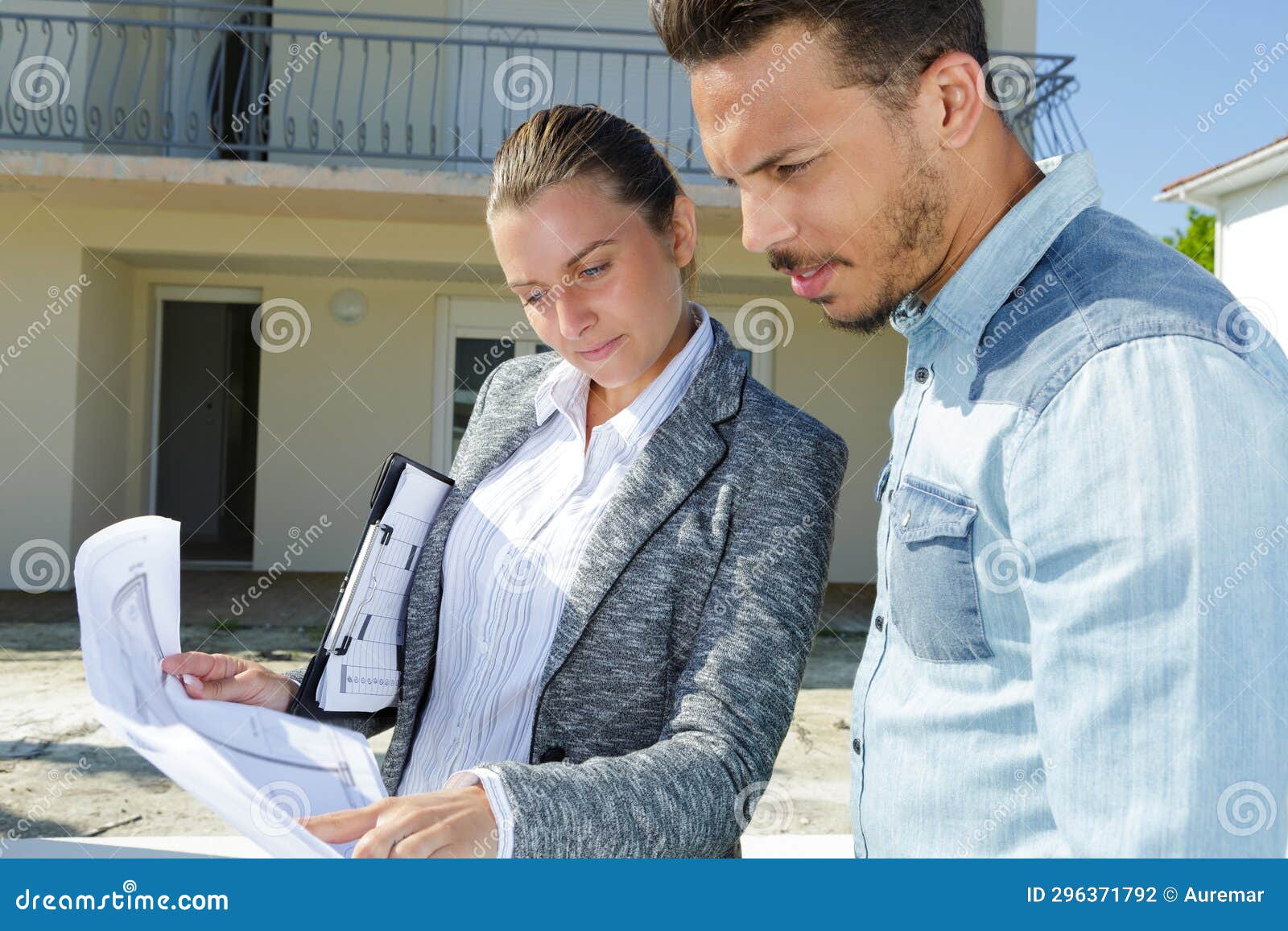Real Estate Sales Representative Showing Plot Blueprint To Client Stock ...