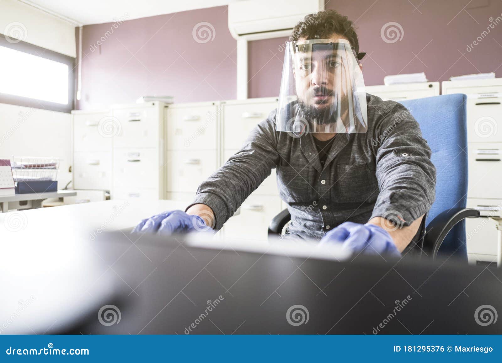 Real Office Worker with Plastic Protective Screen Working on Computer ...