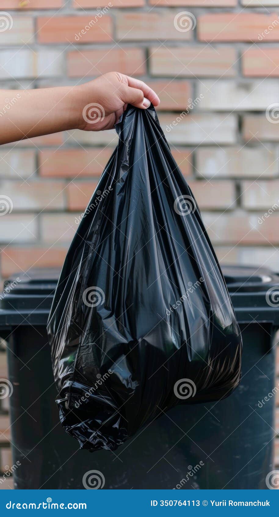 Realistic Image of Hand Placing a Black Trash Bag into a Waste ...