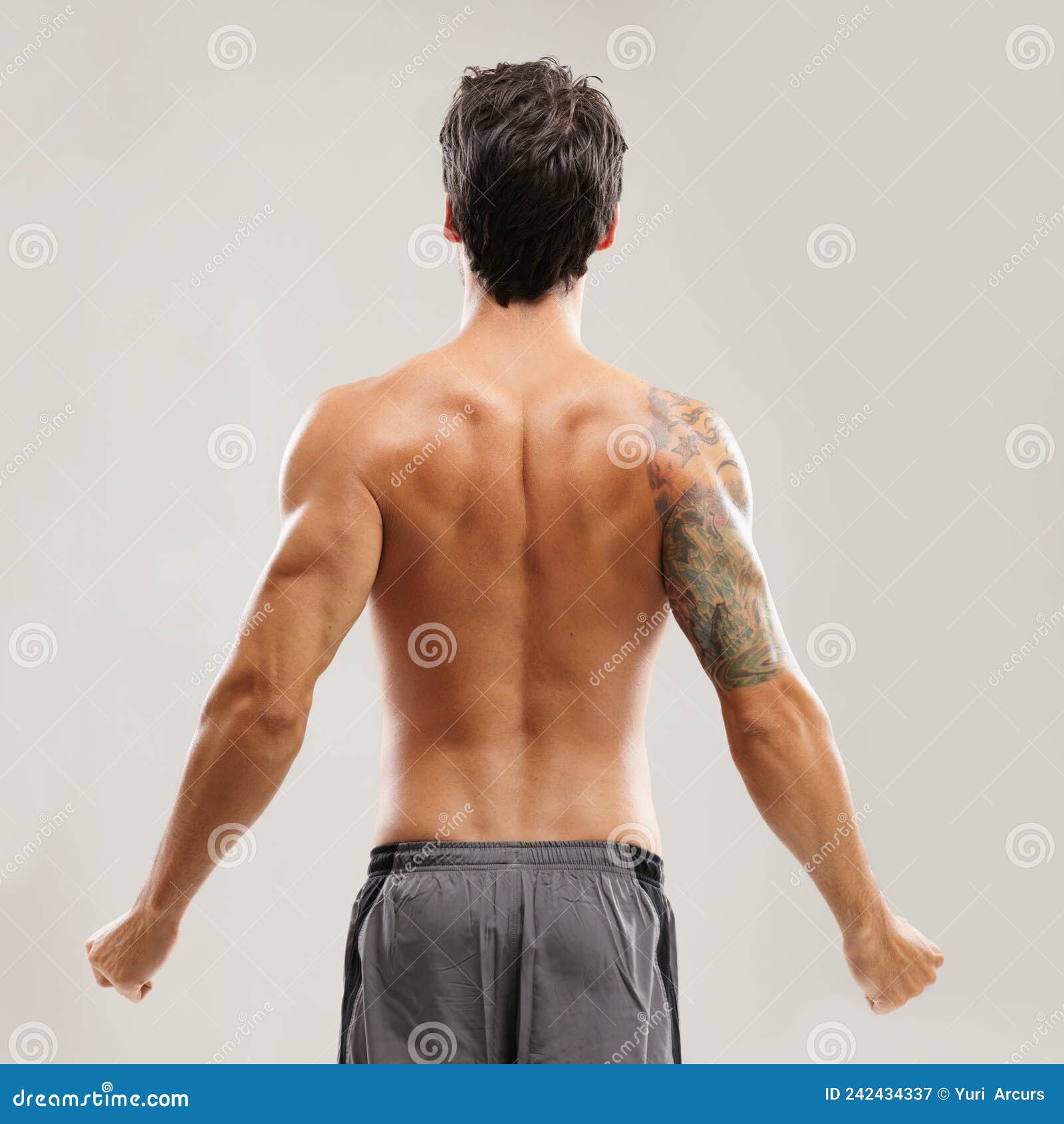 He Realizes the Important of Proper Stretching. Rearview of a Shirtless ...