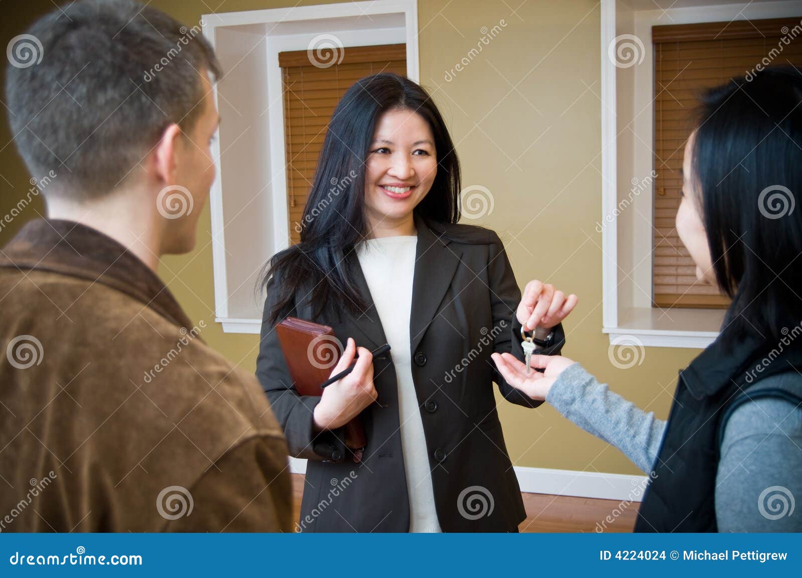 Realtor giving key stock photo. Image of suit, cheerful - 4224024