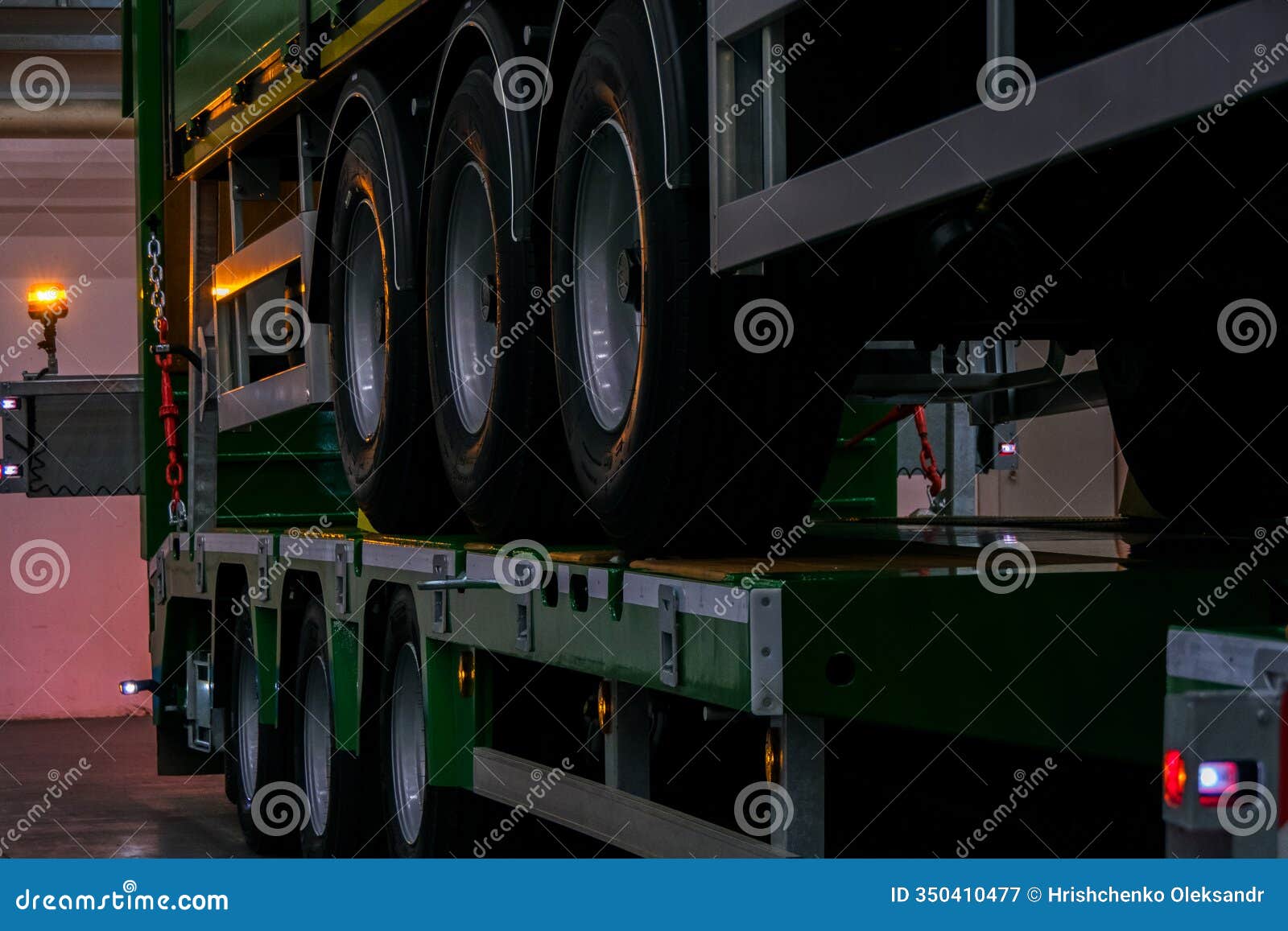 The Rear of a Large Green Truck. it is Equipped with a Low-bed Platform ...