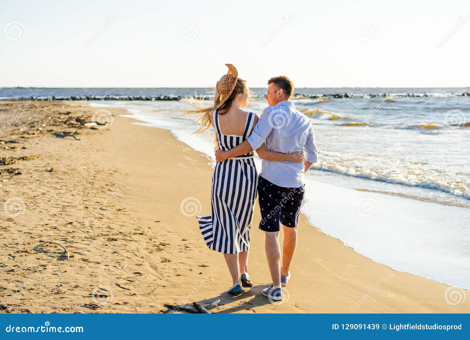 Rear View of Affectionate Couple Walking on Sandy Beach Stock Image ...