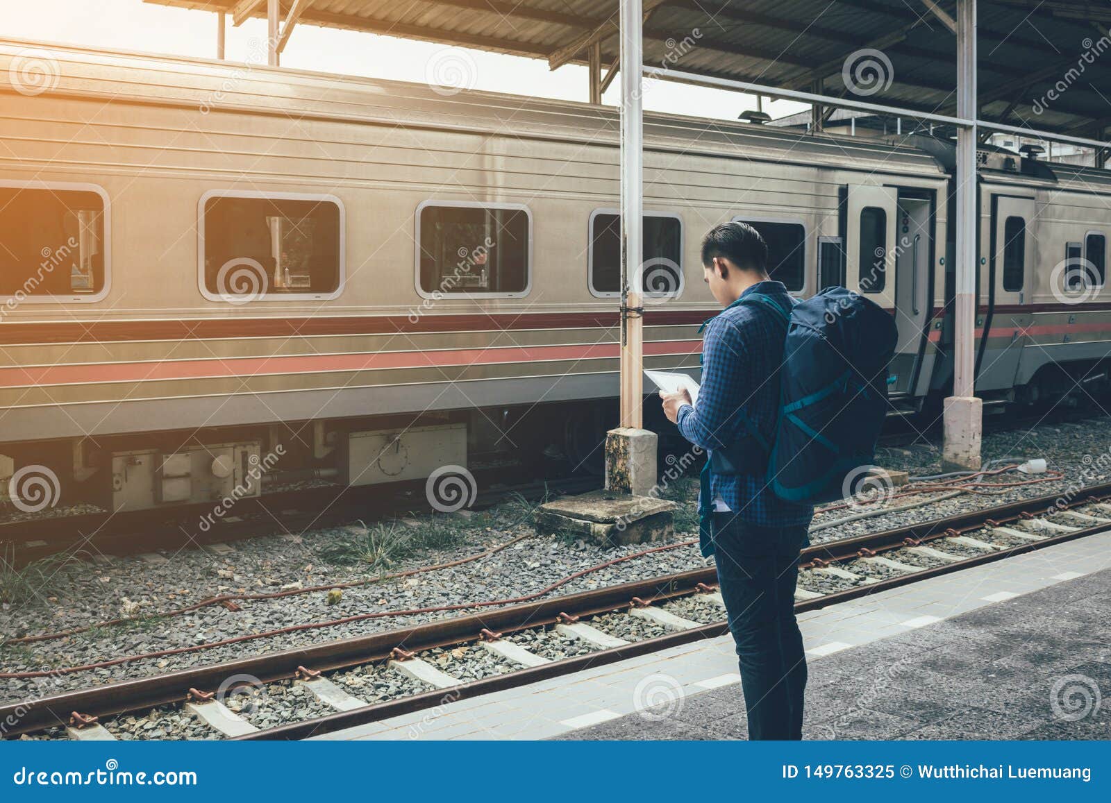 Rear View of Asian Man Waiting Train at Platform and Holding Tablet ...