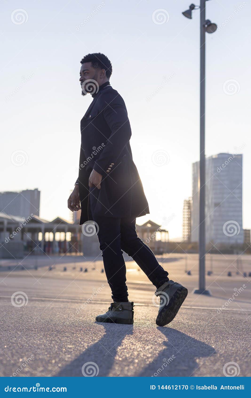 Rear View of a Black Young Bearded Man Walking Outdoors while Looking ...