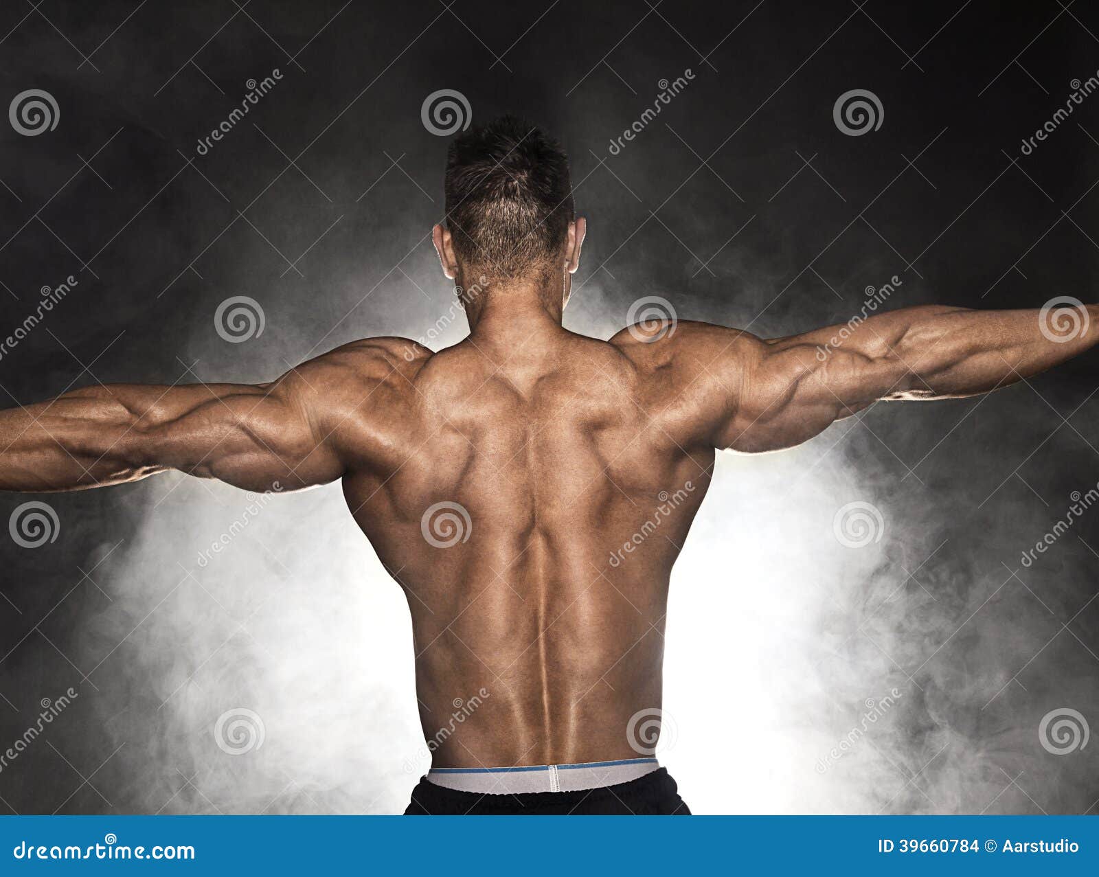 Rear view of bodybuilder stock photo. Image of extended - 39660784