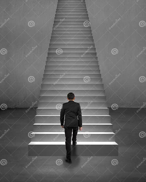 Rear View Businessman Climbing On Stairs With Spot Lighting Stock Image