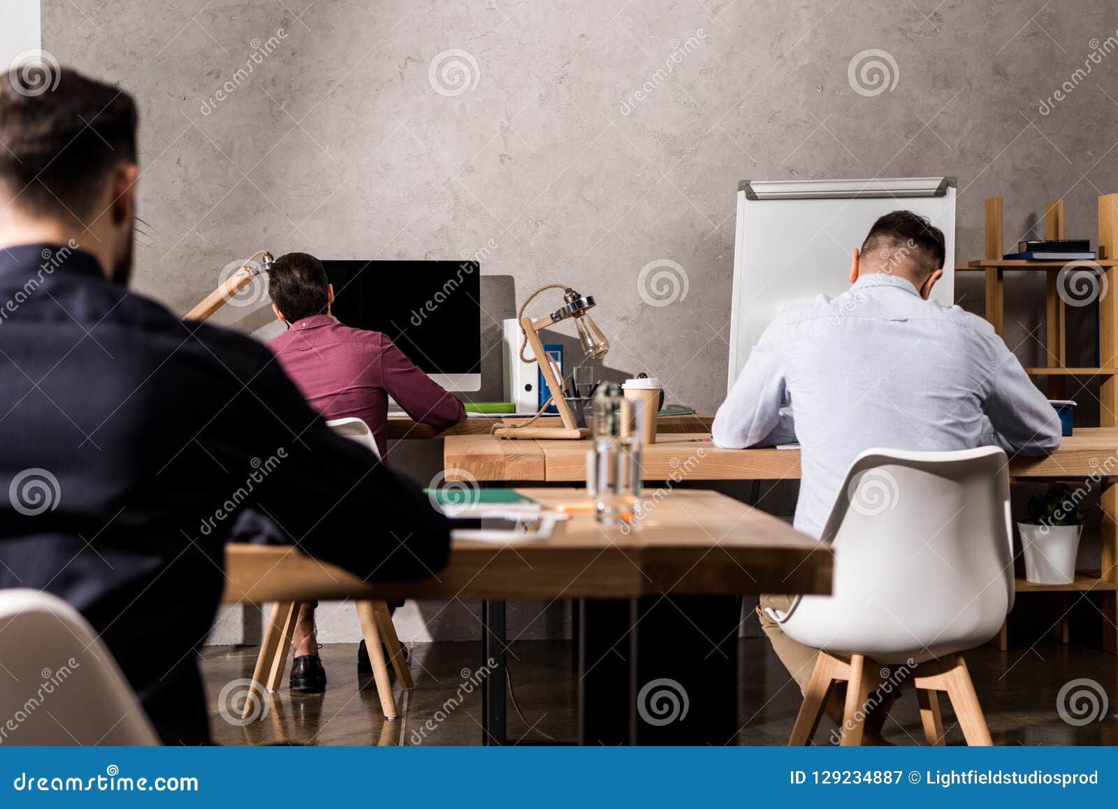 Rear View of Businessmen Sitting at Working Tables Stock Image - Image ...