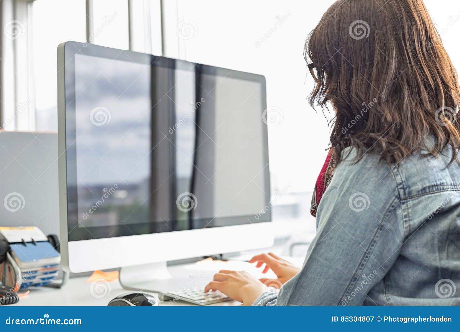Rear View of Businesswoman Using Desktop Computer in Creative Office ...