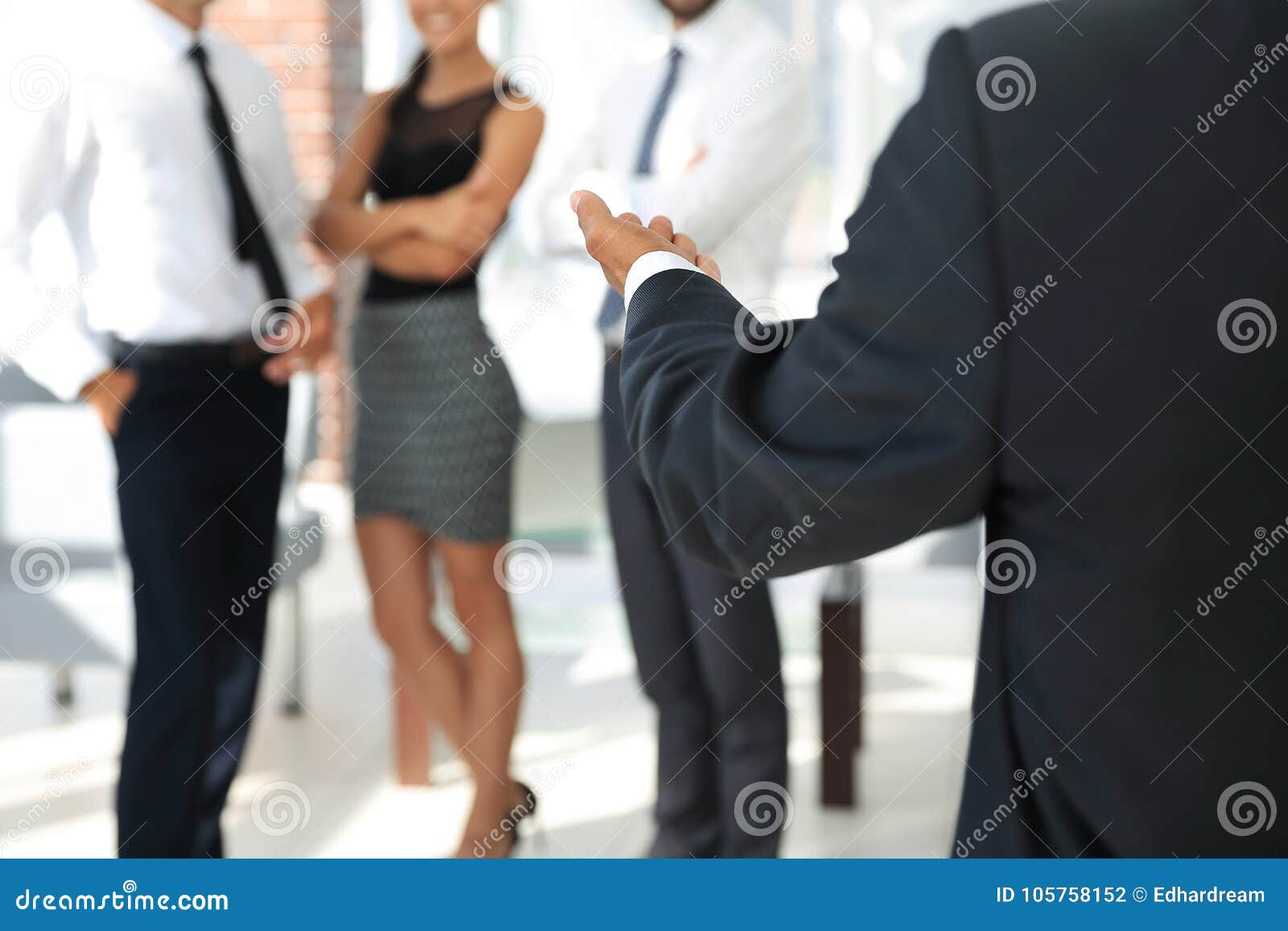 Rear View Closeup Businessman Holding Out Hand For A Handshake Stock
