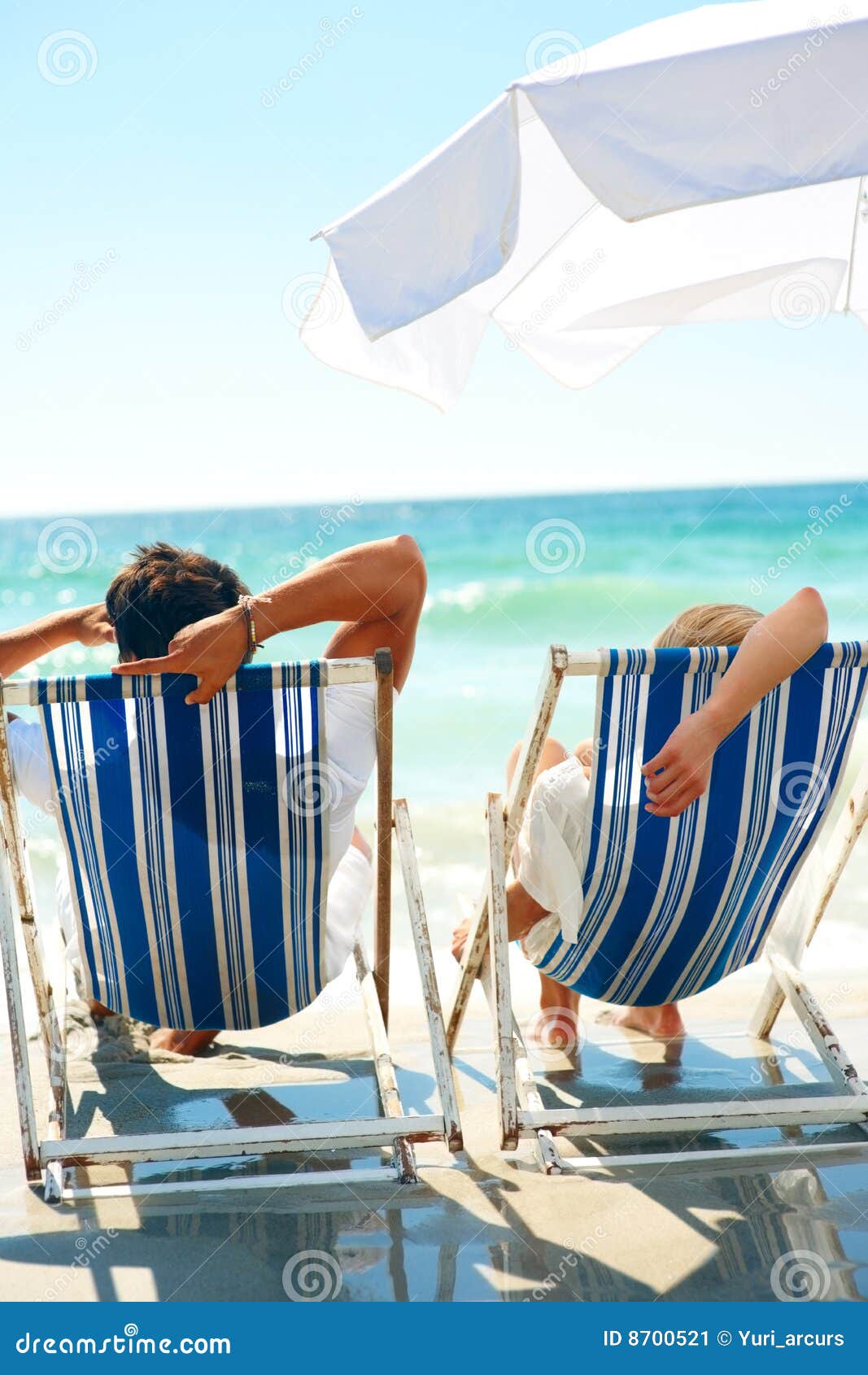 Rear View of a Couple Resting by the Beach Stock Image - Image of back ...