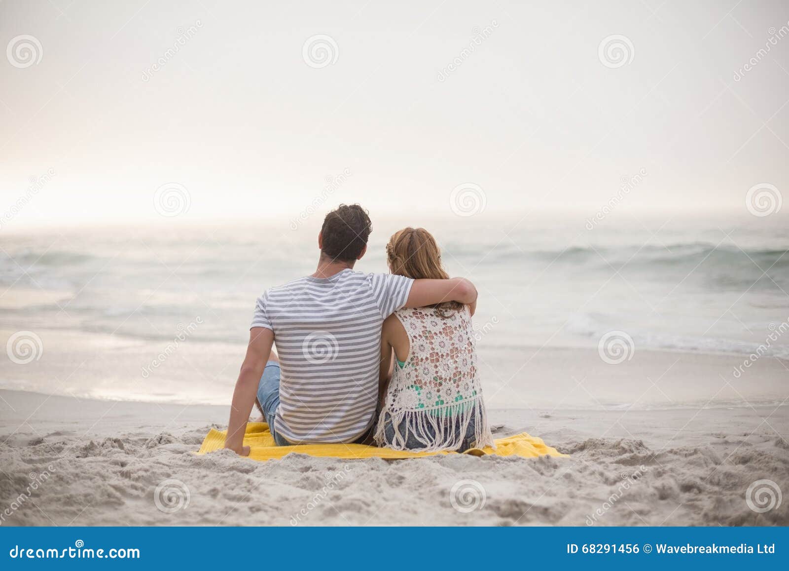 Rear View of Couple Sitting on the Beach Stock Photo - Image of ...