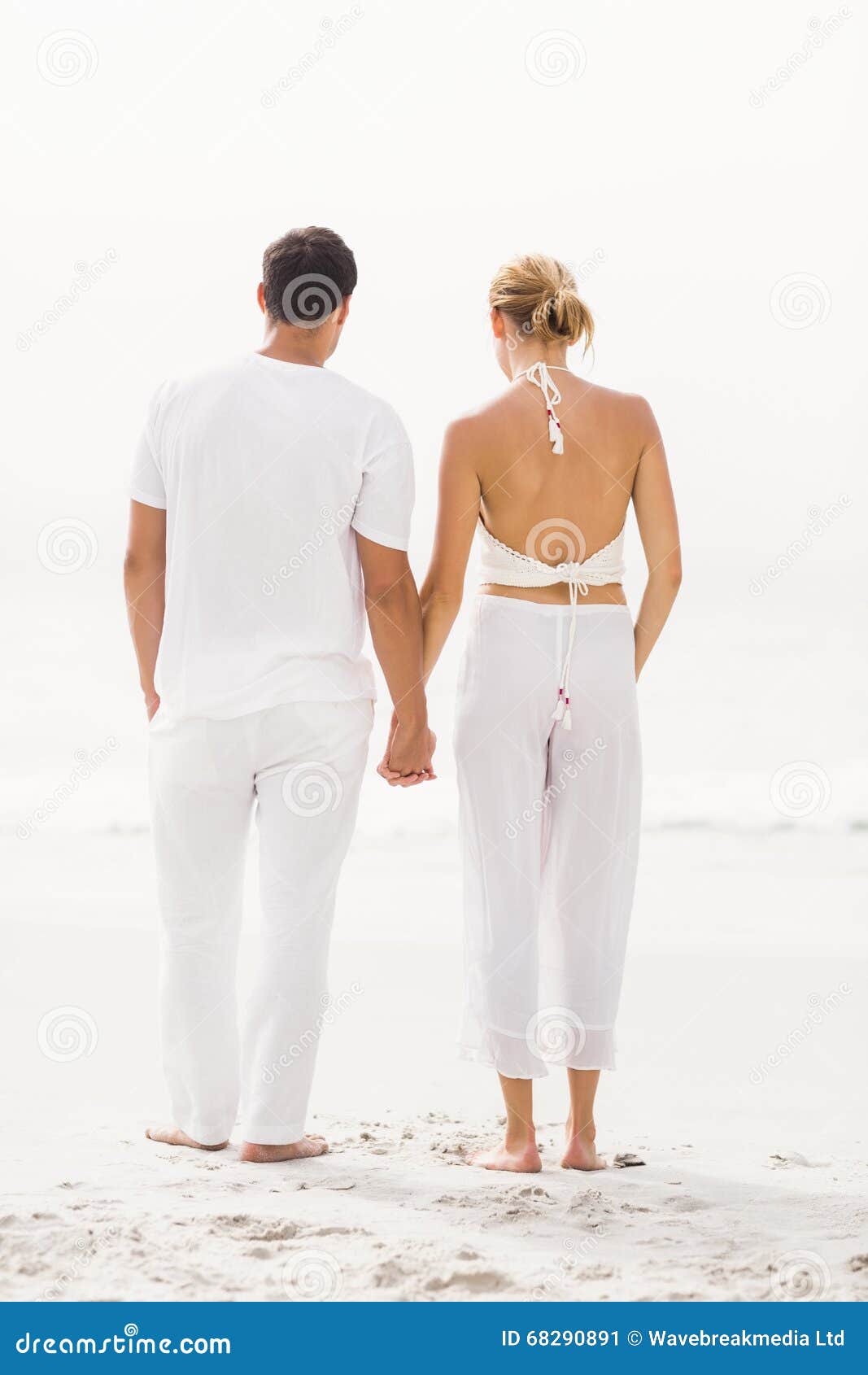 Rear View of Couple Standing on the Beach Stock Image - Image of focus ...