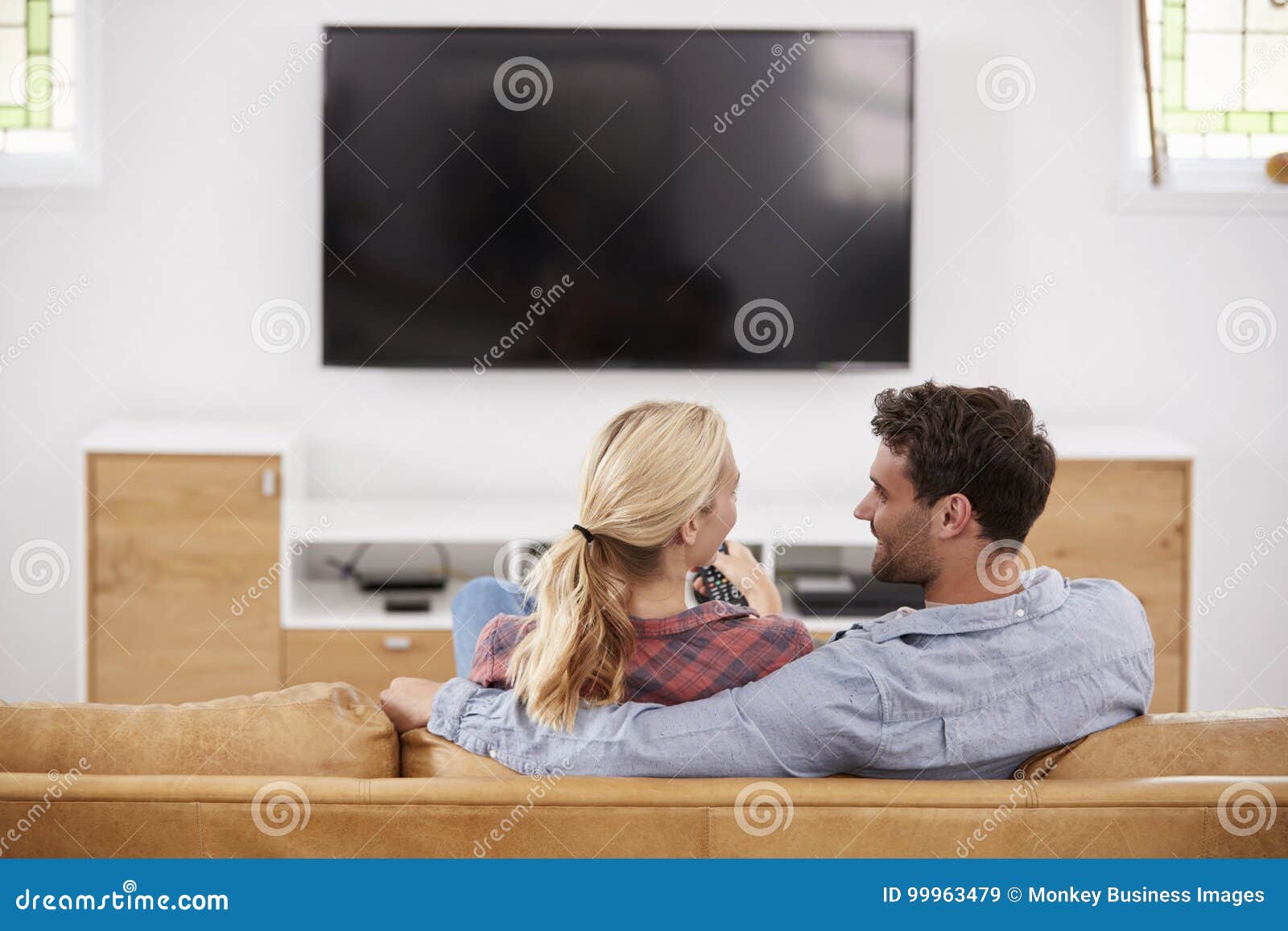 Rear View of Couple Watching Television Together Stock Image - Image of ...