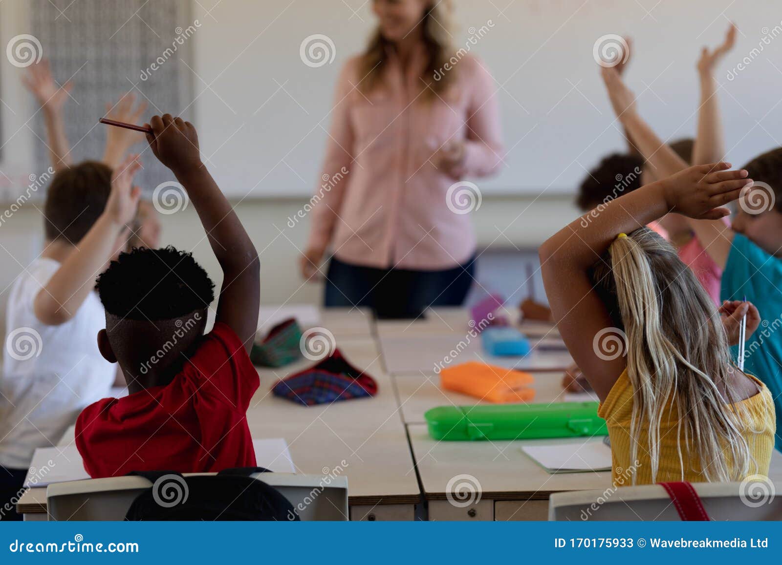 Schoolboy Raising Their Hands in an Elementary School Classroom Stock ... Schoolboy Raising Their Hands in an Elementary School Classroom Stock ...