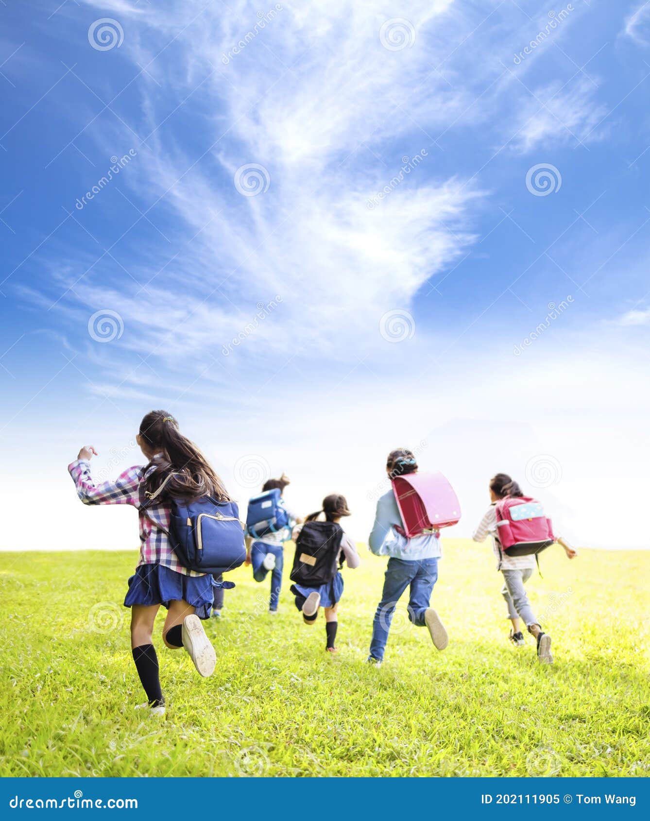 Rear View of Elementary School Kids Running on the Grass Stock Image ...