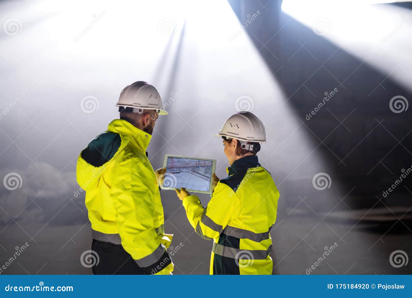 Two Engineers Man Standing In Front Of Windows And Used Tablet To Find ...