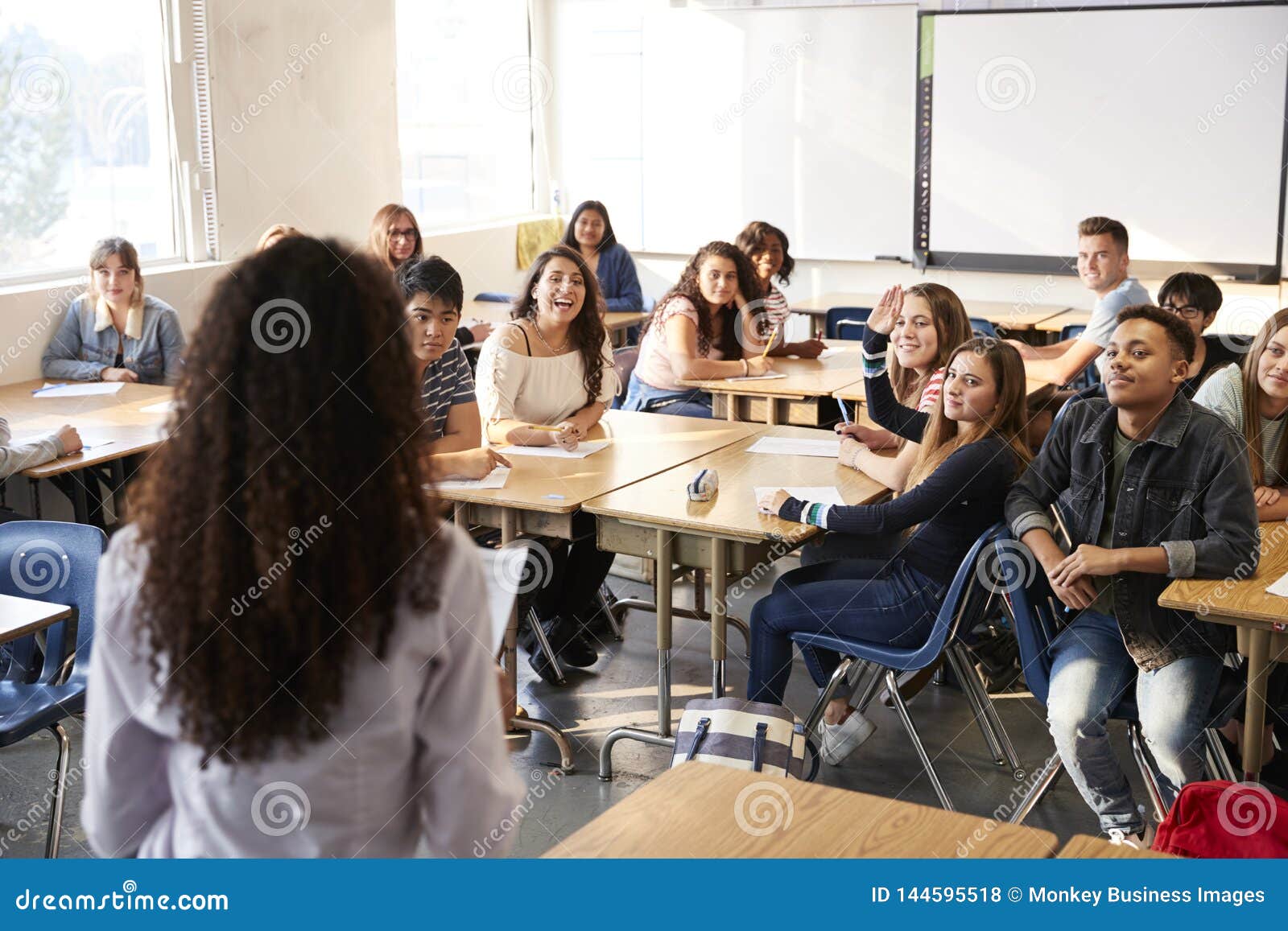 Rear View of Female High School Teacher Standing at Front of Class ...