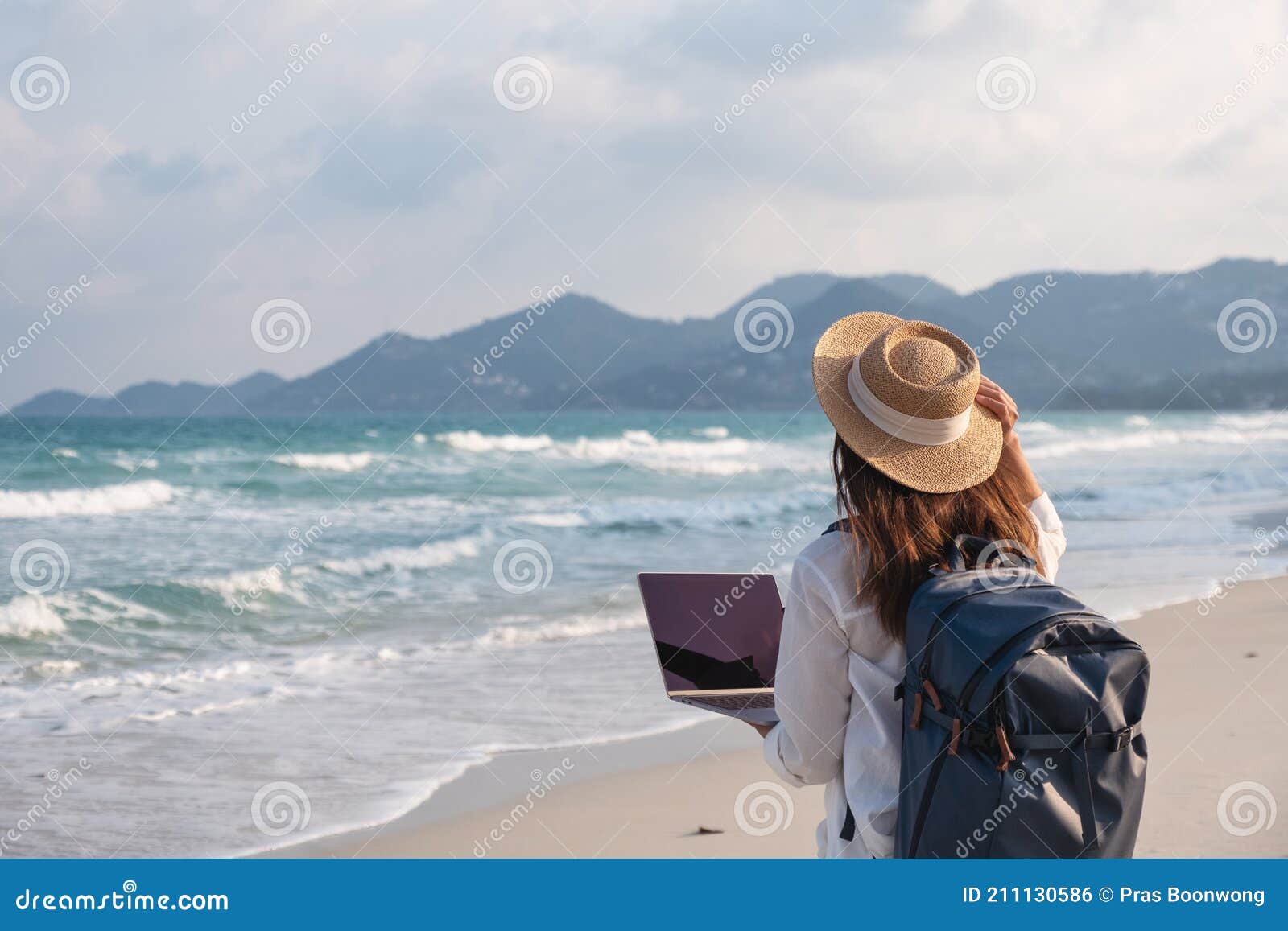 A Female Traveler Using and Working on Laptop Computer while Walking on ...
