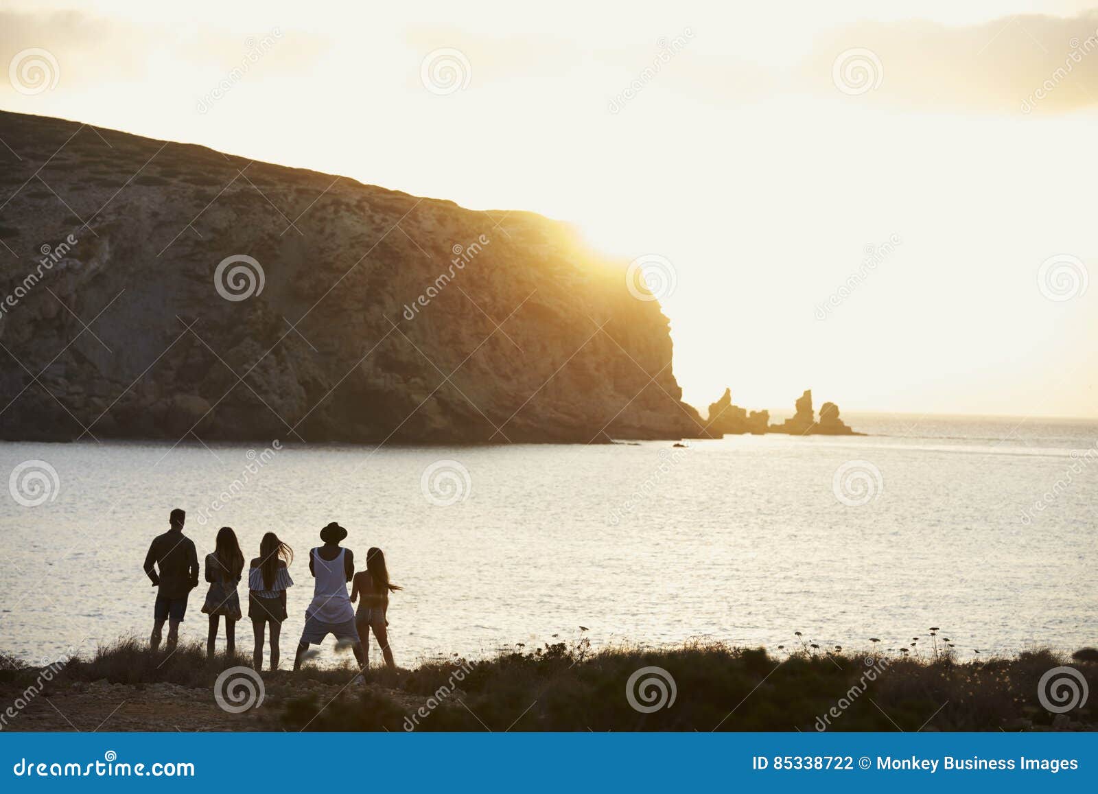 Rear View of Friends Standing on Cliff Watching Sunset Stock Photo ...