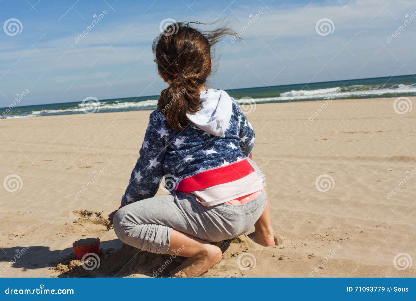 Rear View Girl Playing with the Sand in the Beach in a Windy Day Stock ...