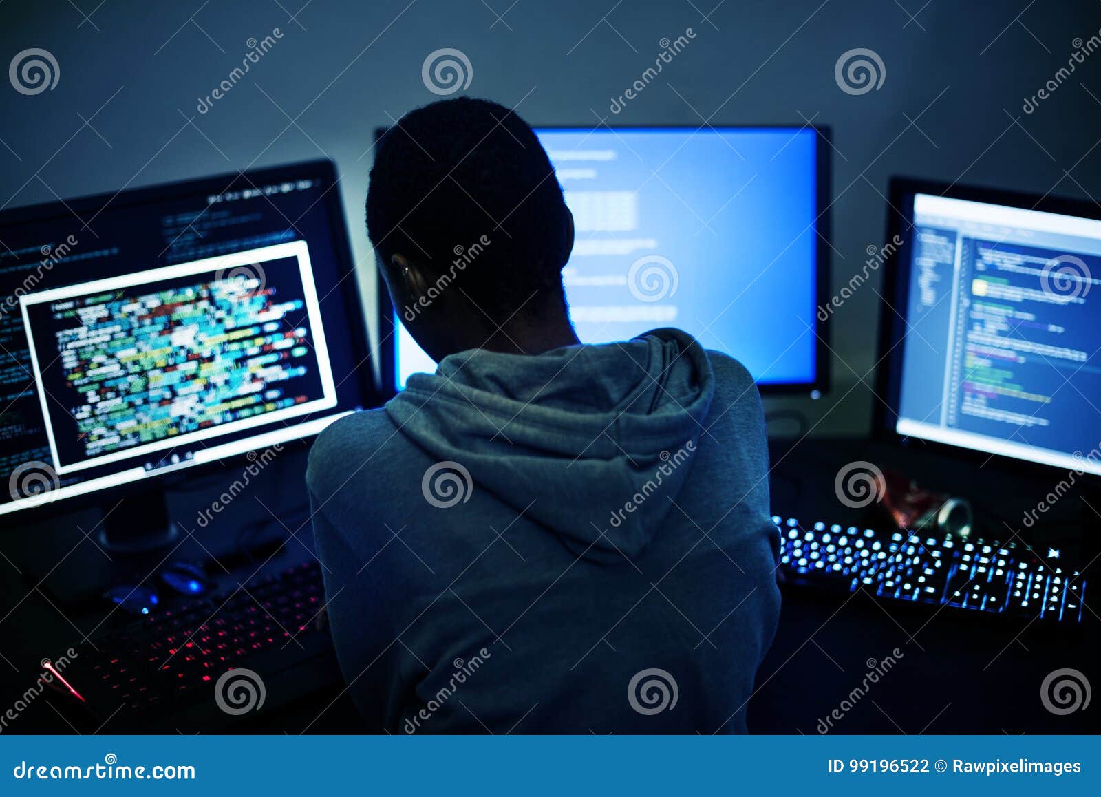 Hacker Working On Multiple Devices While Encrypted Data Flows Across ...