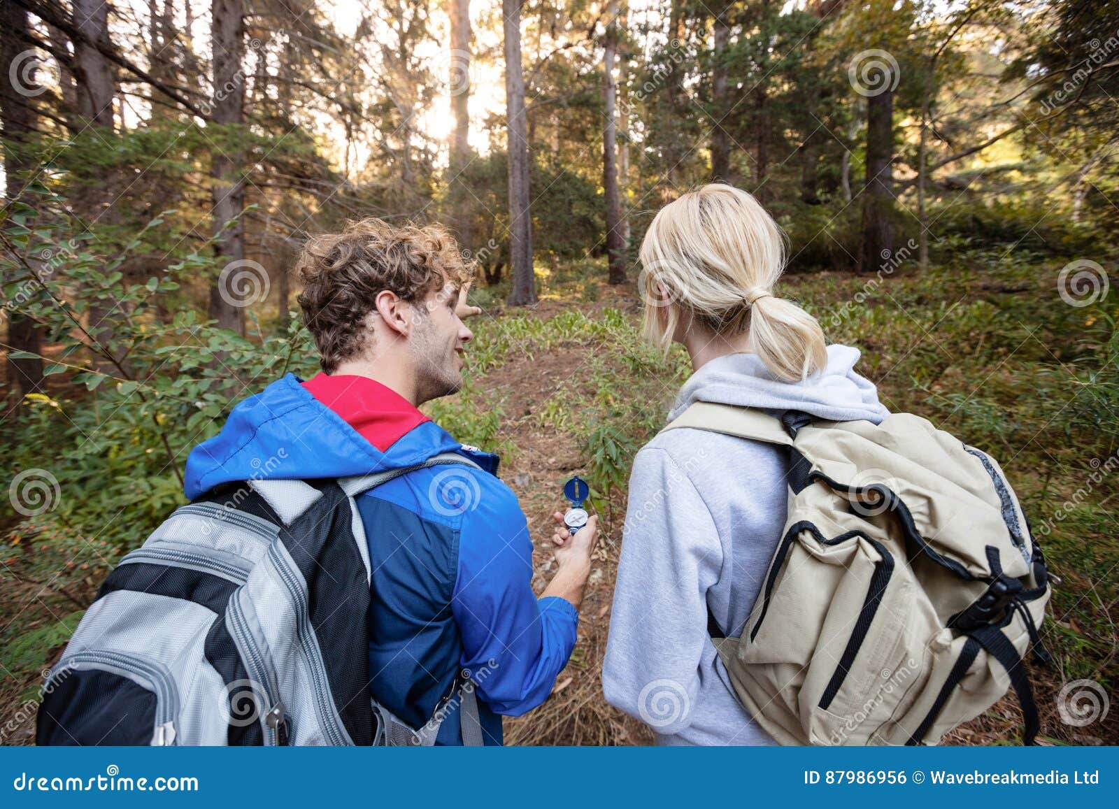 Rear View of Hiking Couple Holding a Compass and Pointing Forward Stock ...