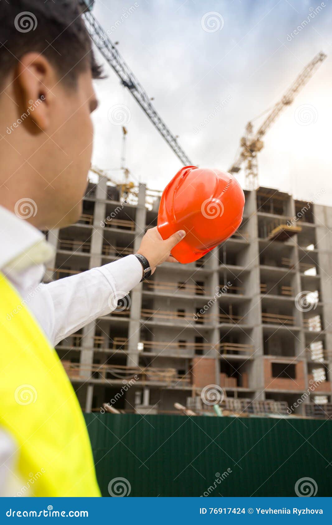 Rear View Image of Construction Engineer Pointing at Building Si Stock ...