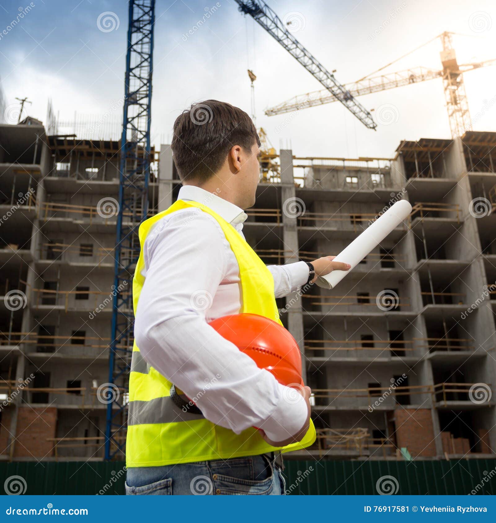 Rear View Image of Young Engineer Pointing at Building with Blue Stock ...