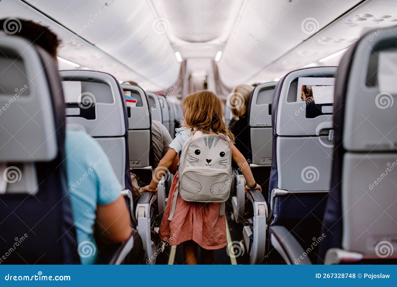 Rear View of Little Girl Standing in Aisle in the Plane. Stock Photo ...