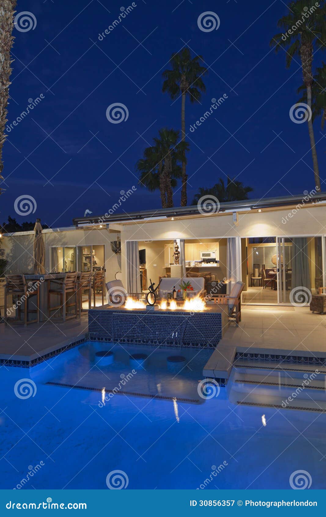 Rear View of Luxury Villa at Night Time with Lit Fire Stock Image ...