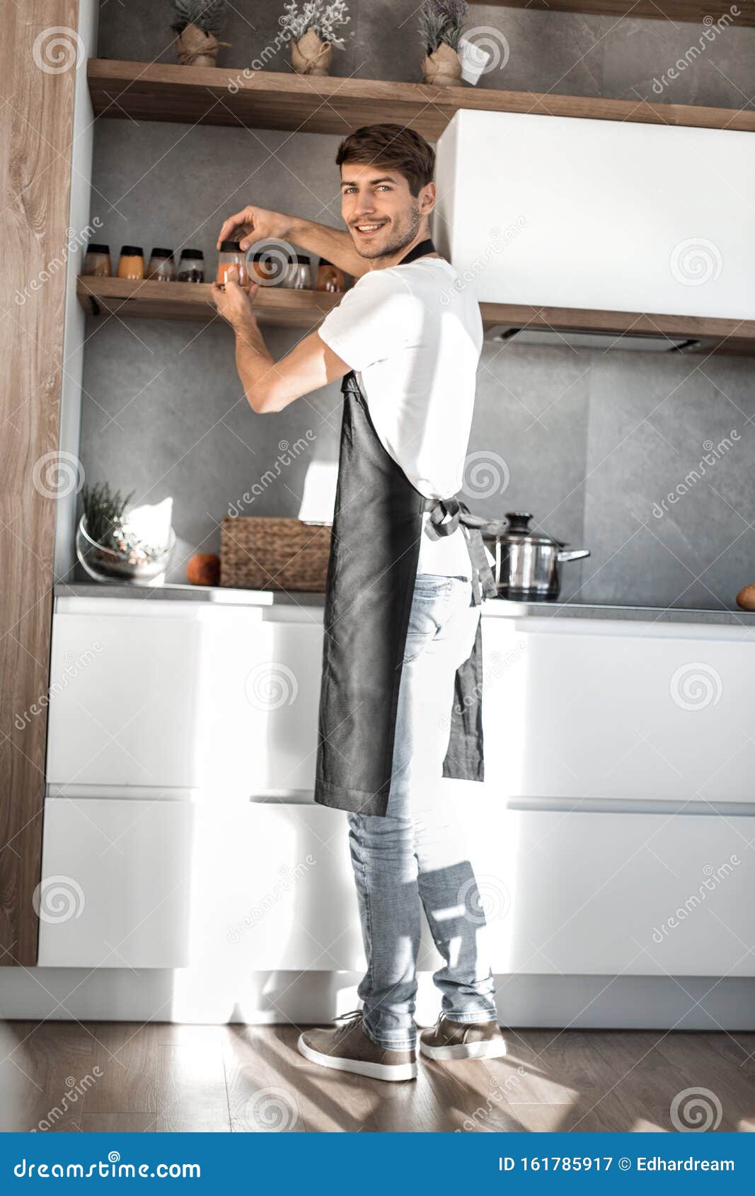 Rear View. a Man Chooses Spices for Cooking Dinner Stock Image - Image ...