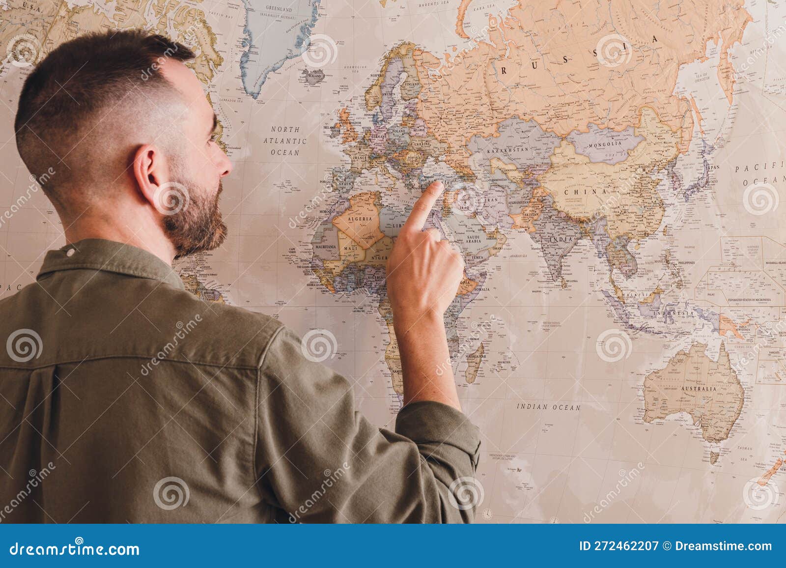Rear View of Man Pointing Vintage Map with His Finger Stock Image ...