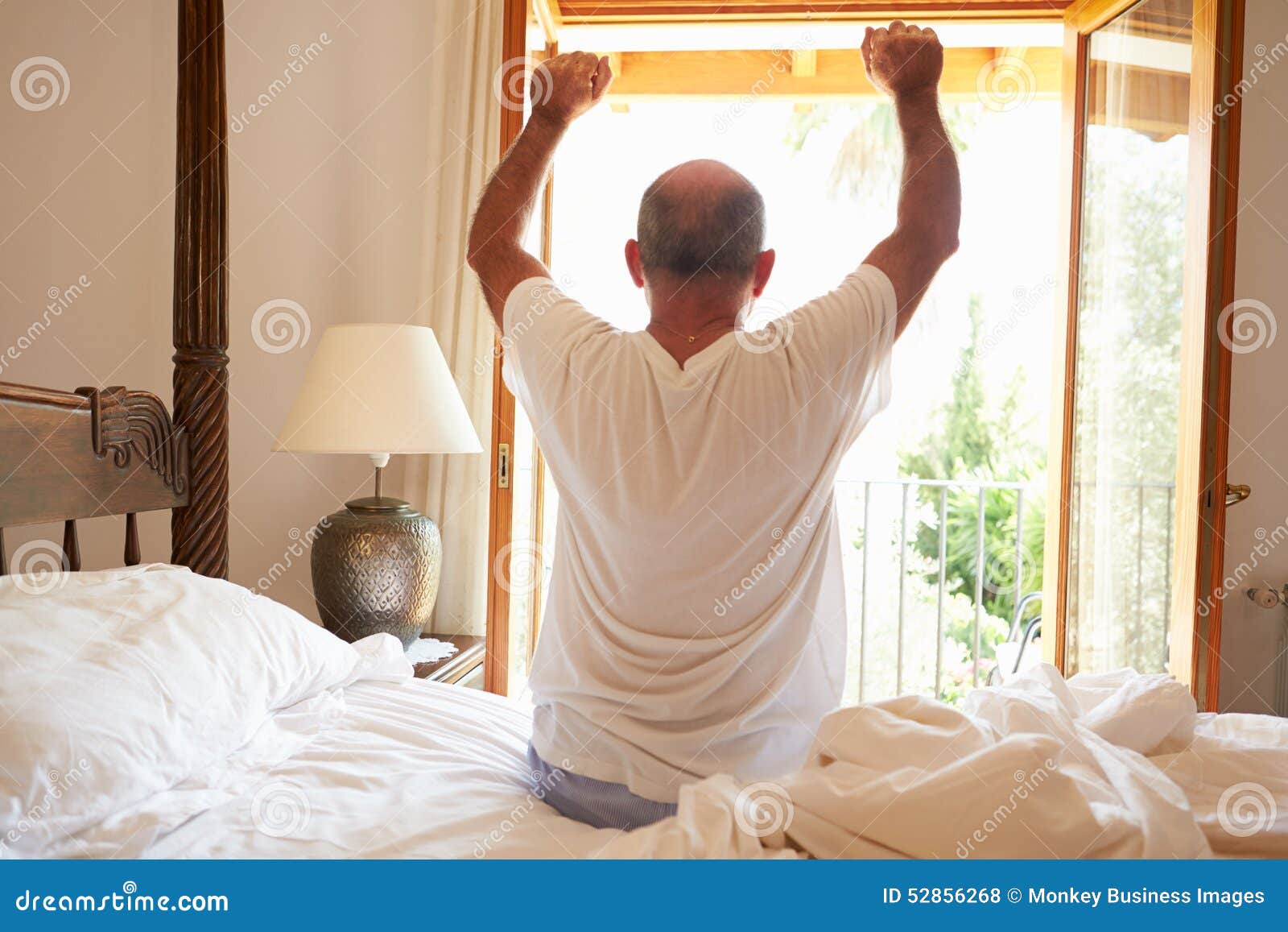 Rear View of Man Waking Up in Bed in Morning Stock Photo - Image of ...