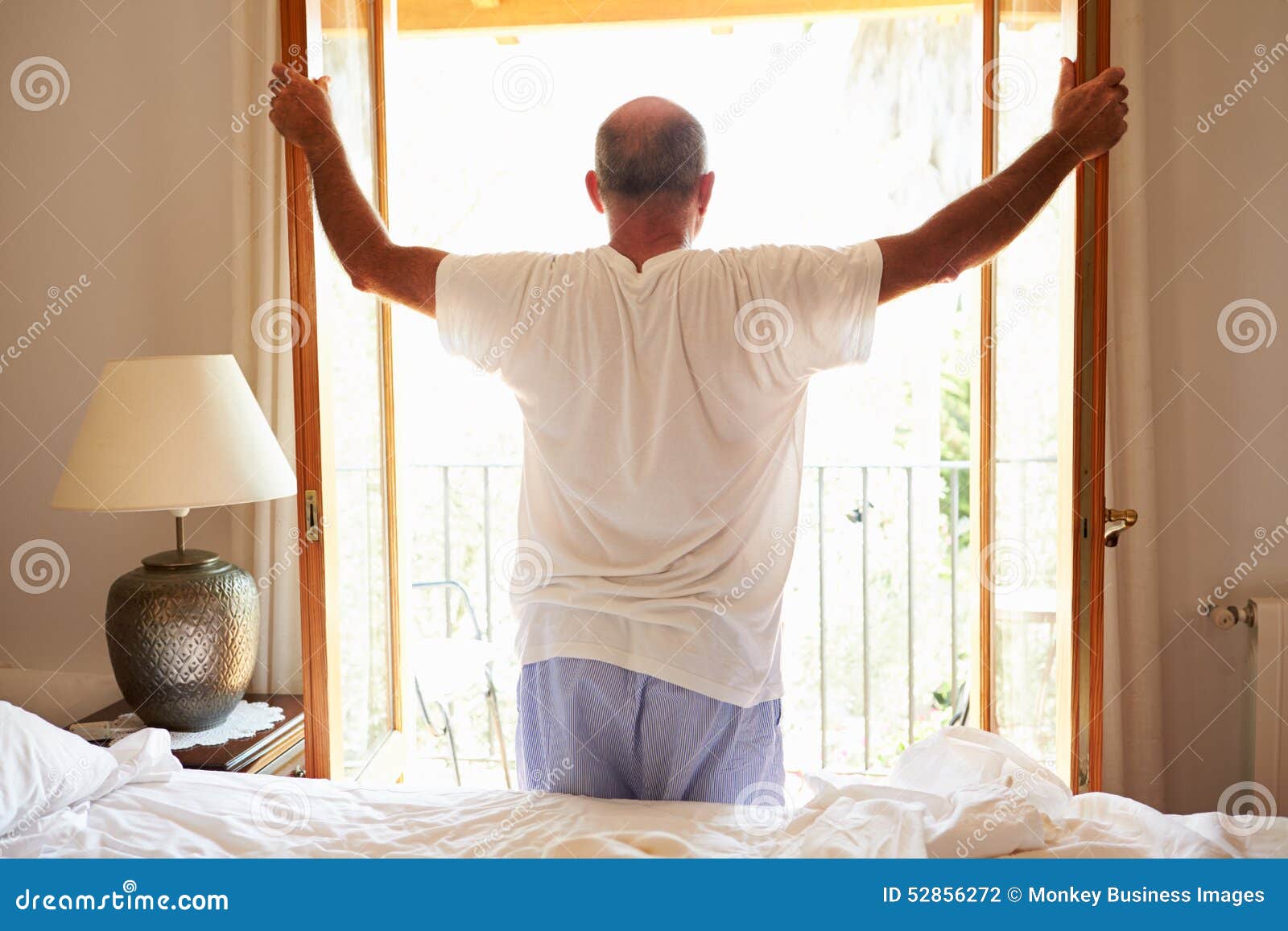 Rear View of Man Waking Up in Bed in Morning Stock Photo - Image of ...