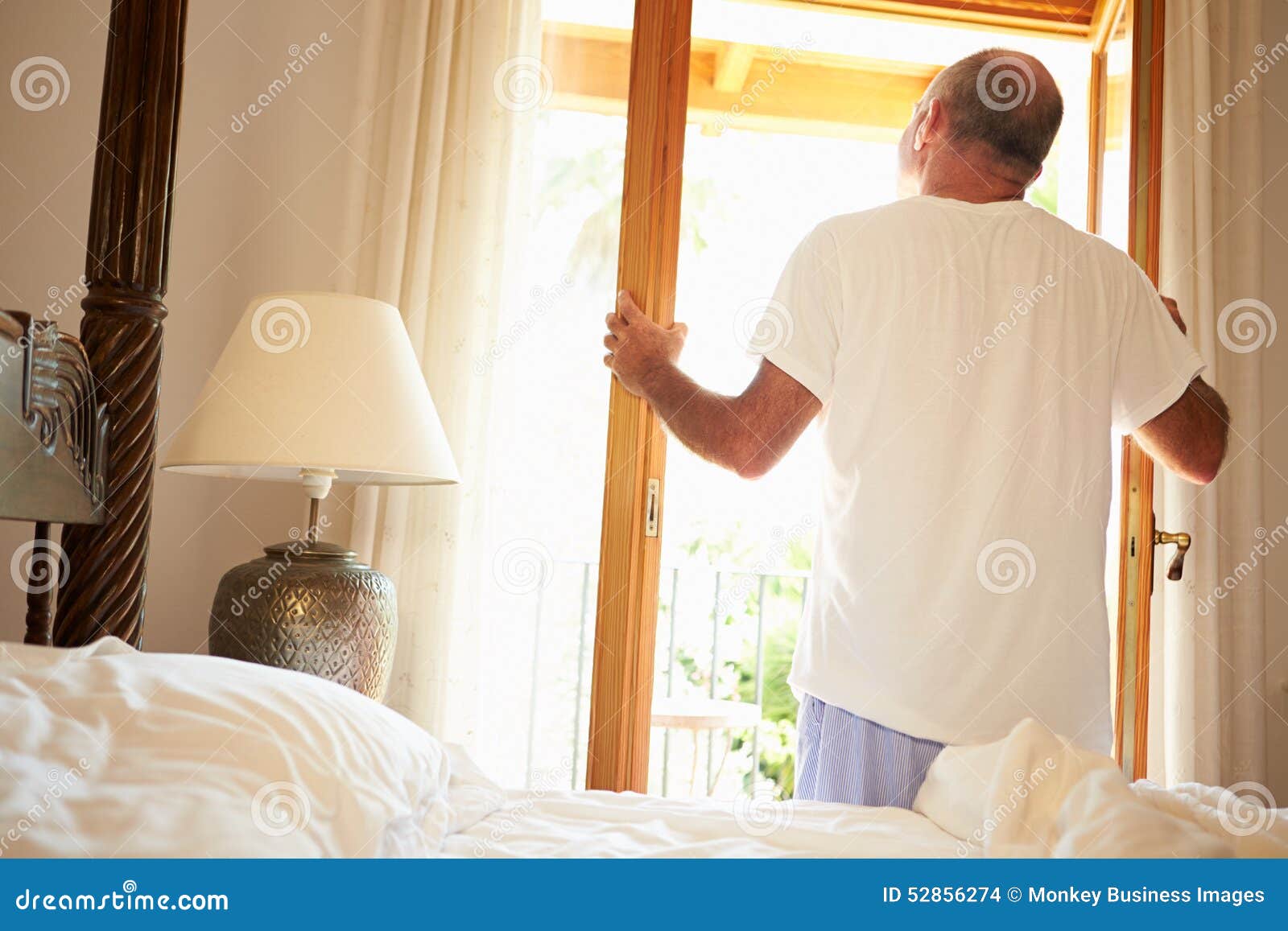 Rear View of Man Waking Up in Bed in Morning Stock Photo - Image of ...